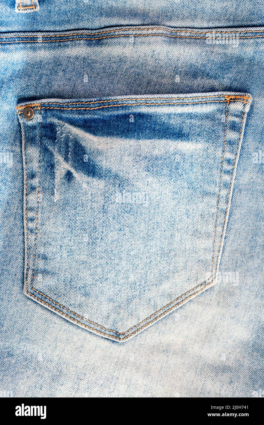 Vertical view of old faded jeans back pocket. Fashion background Stock ...