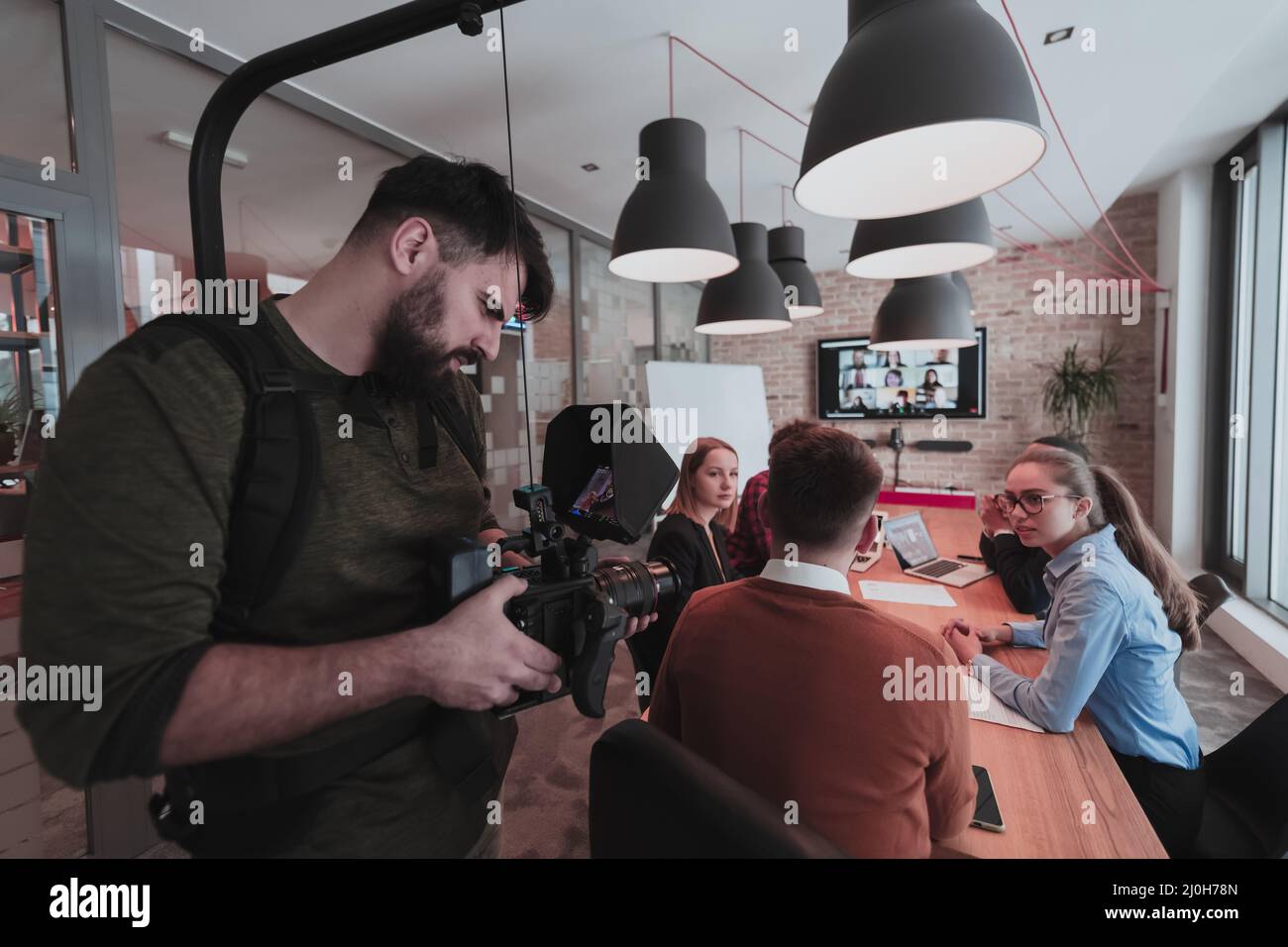 Behind the scene. Cameraman recording a group of young multiethnic ...