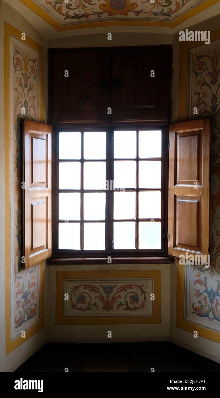 interior view of a ancient old window made of wood and decorated wall ...
