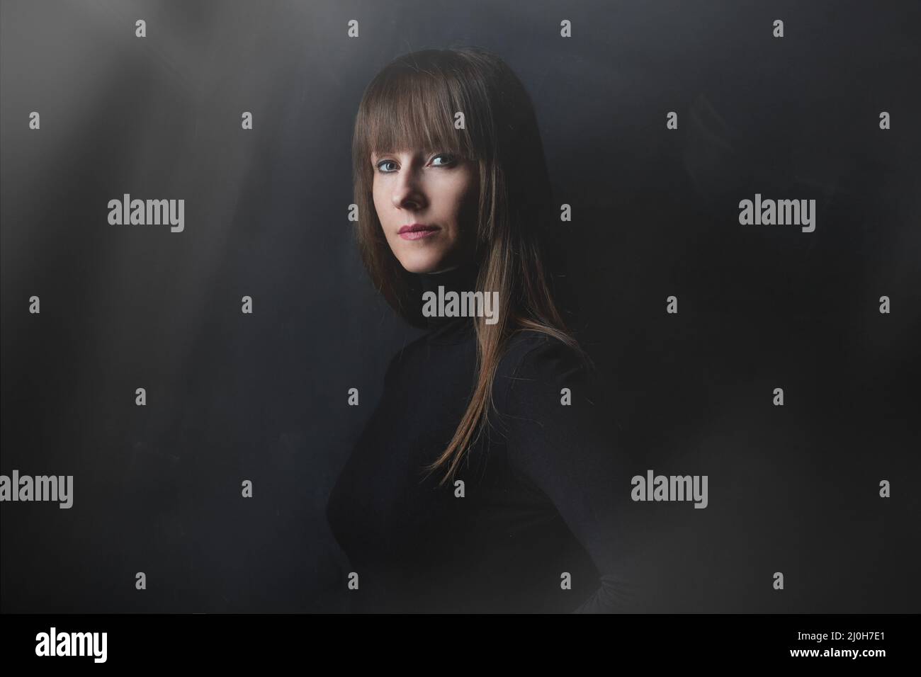 Beauty portrait of attractive young woman looking at camera, serious ...