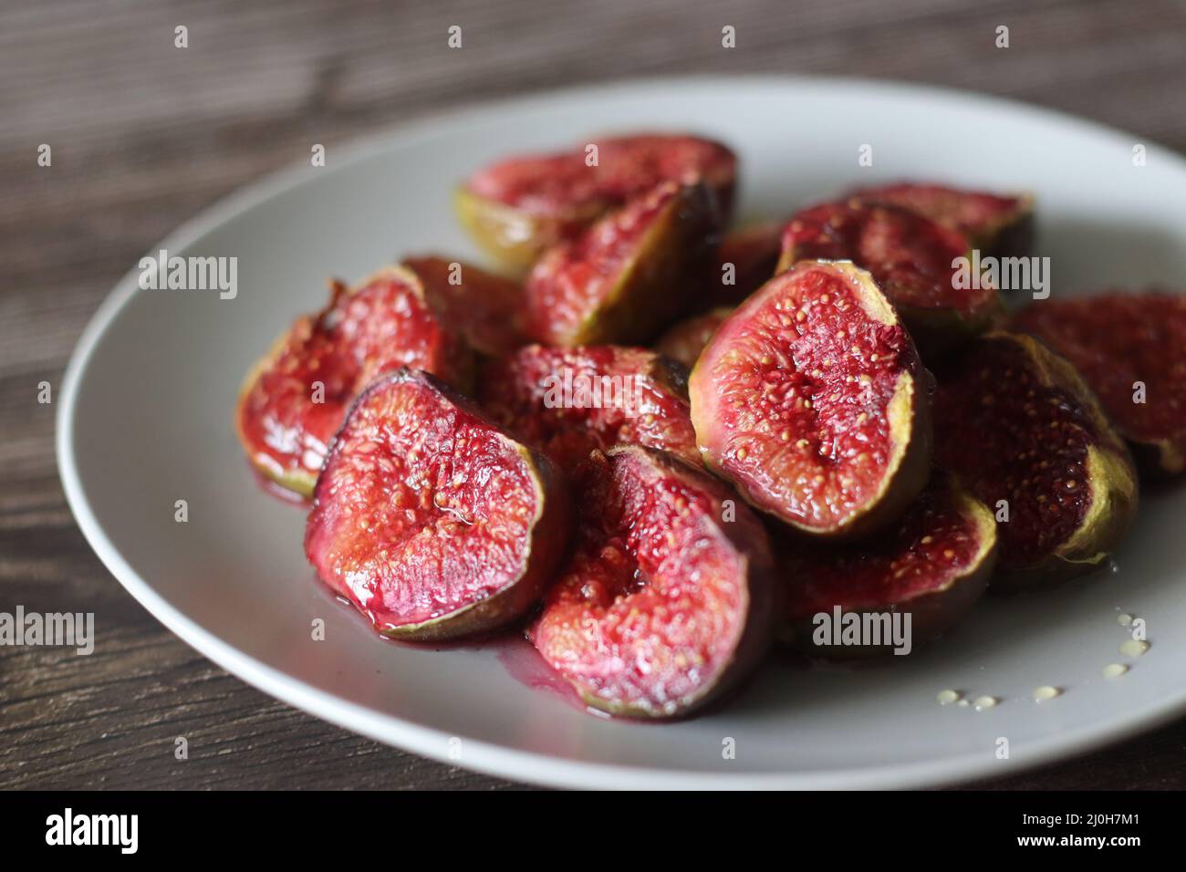 Roasted Fig halves served with a drizzle of honey. Roasting is done ...