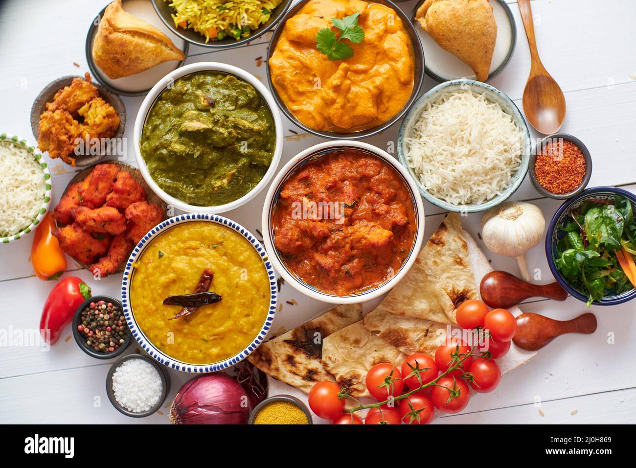 Assorted Indian various food with spices, rice and fresh vegetables ...