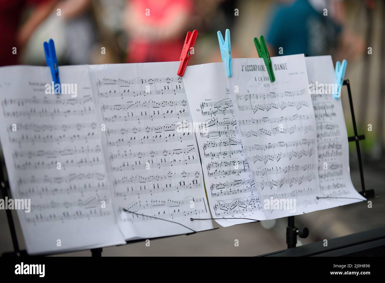 Pages with musical notes on a holder on a blurred background Stock ...