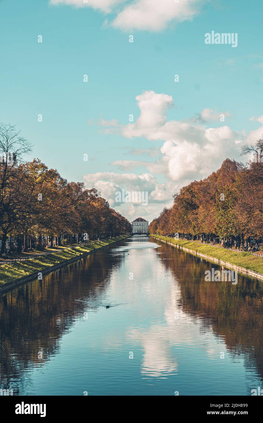Beautiful autumnal scene of a river and colorful trees in Munich Stock ...