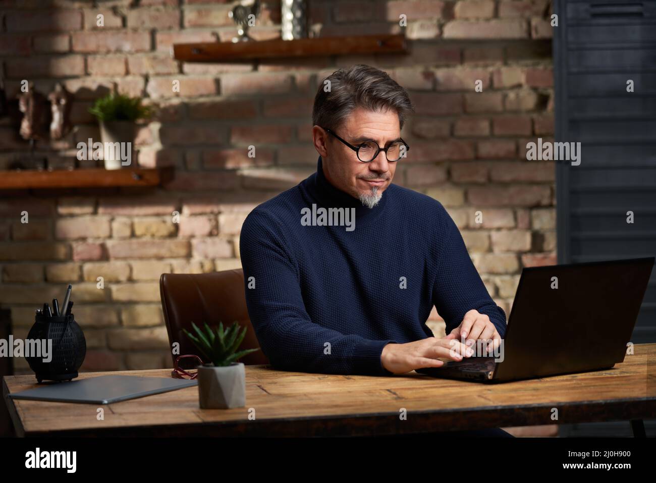 Stay at home - Smart looking older business man working in home office ...