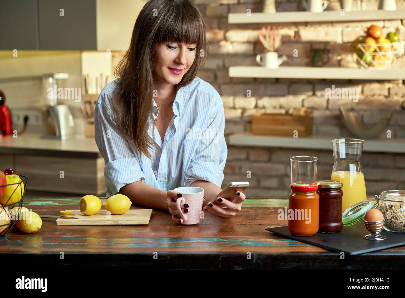In sunny kitchen young woman hi-res stock photography and images - Alamy