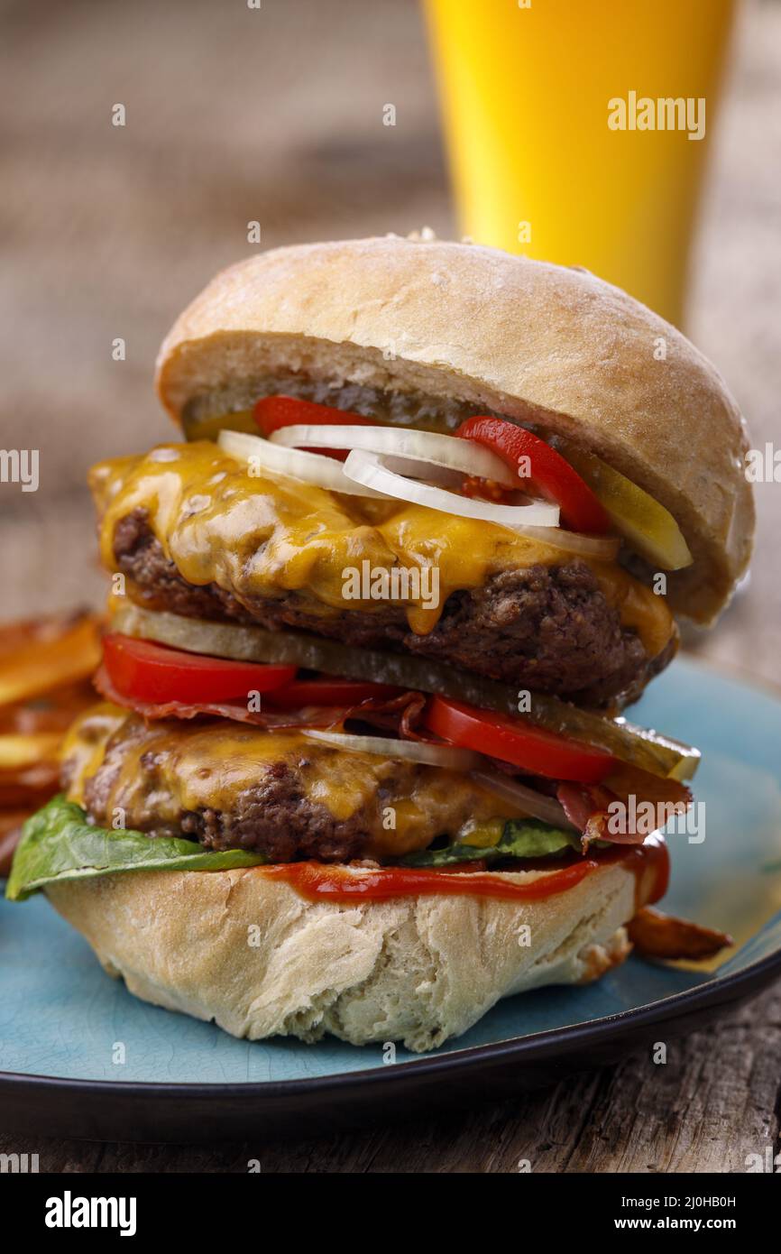 Homemade cheeseburger on wood Stock Photo - Alamy