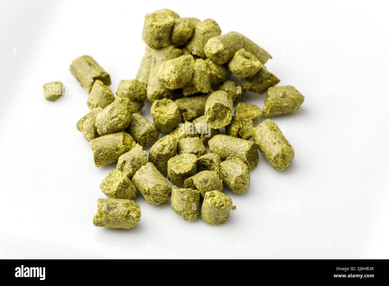 Hop pellets for brewing on white Stock Photo - Alamy