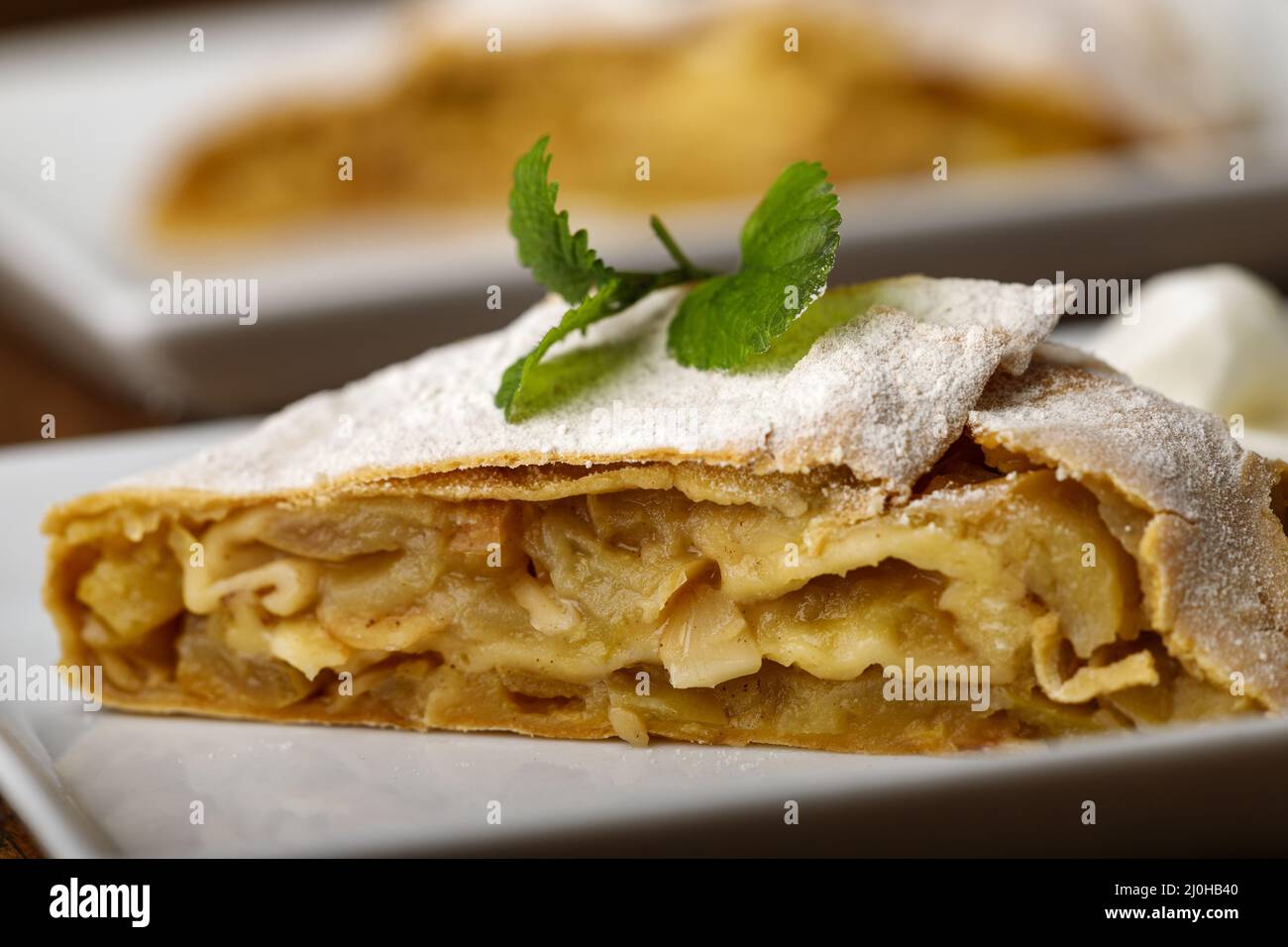 Austrian apple strudel on white plates Stock Photo - Alamy