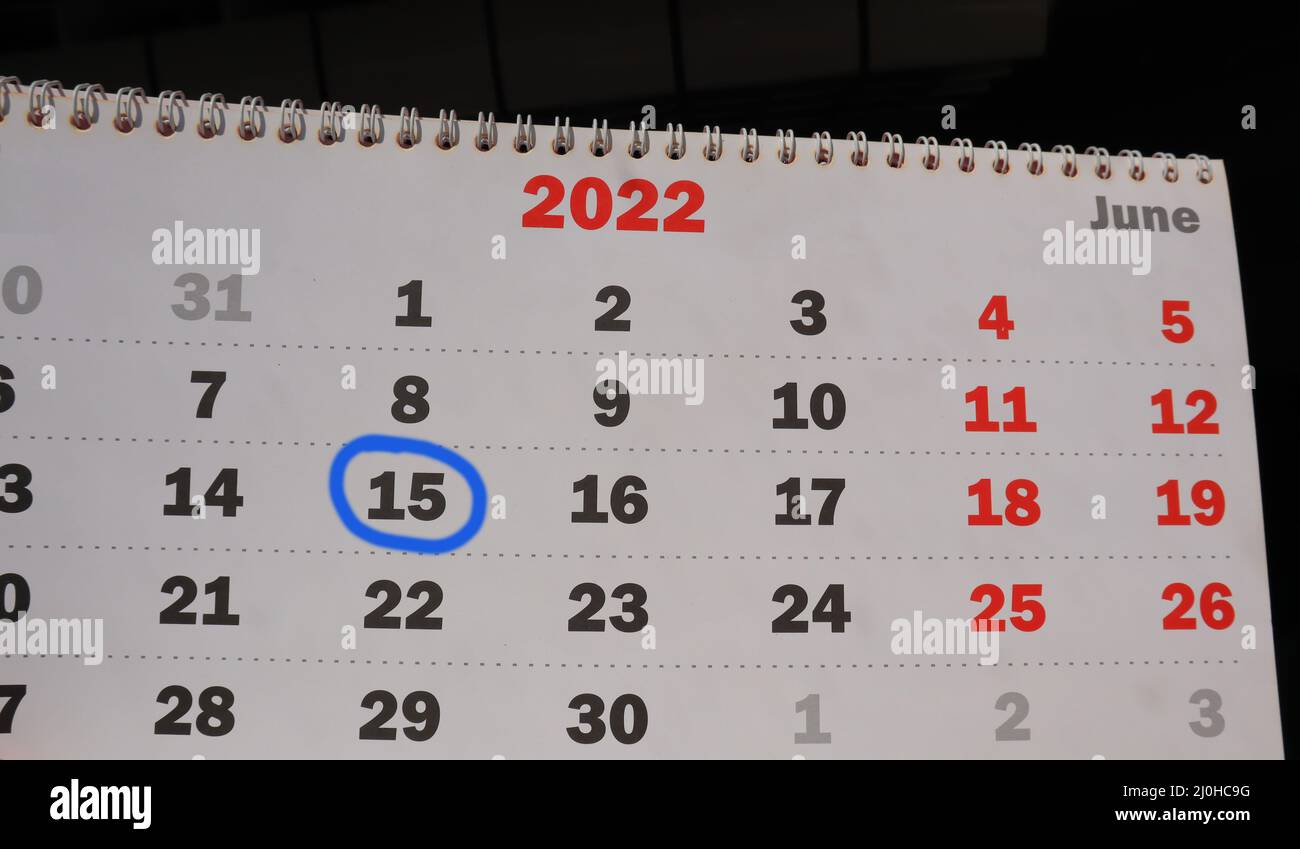Close-up of a paper calendar page with a marked date of June 15, 2022 ...