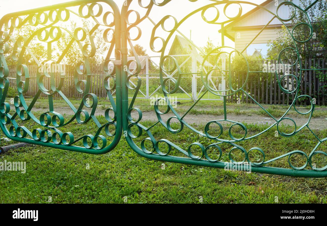 Vintage green metal gate with a lock, the concept of security and ...