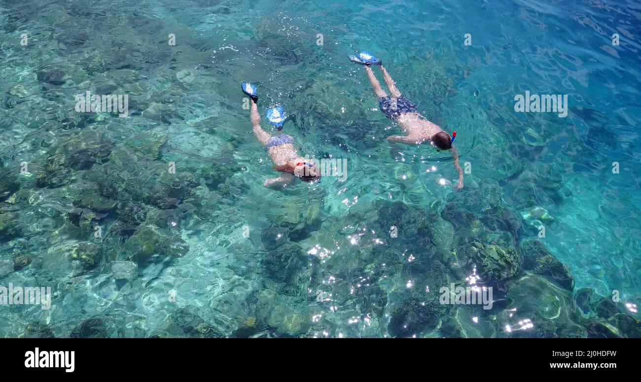 Aerial view of a couple swimming in the ocean in Rasdhoo Island ...