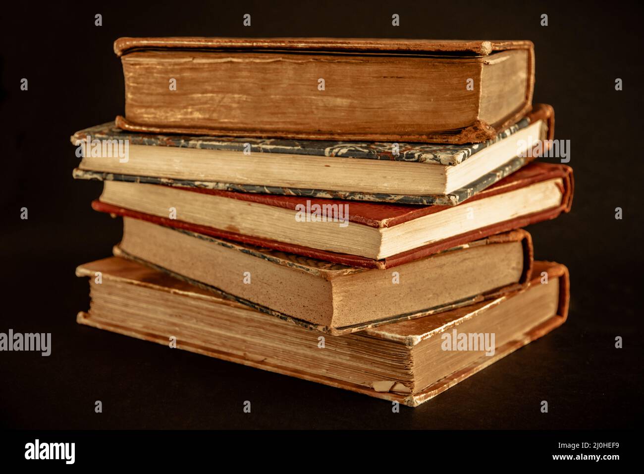 Stack of old books on black background Stock Photo - Alamy
