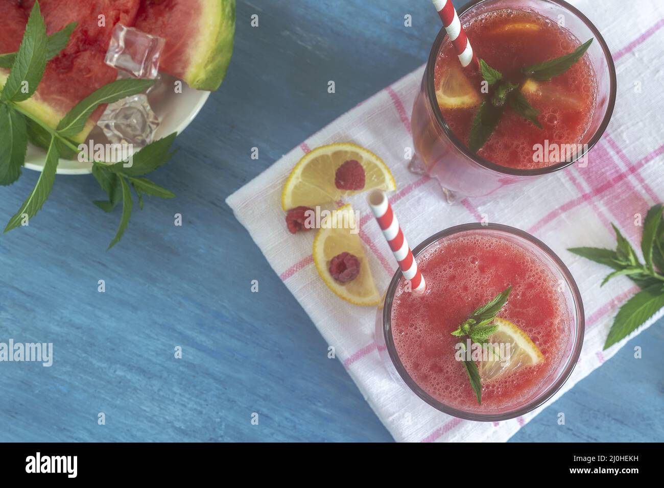 Watermelon juice in a glass with lemon and raspberries Stock Photo - Alamy