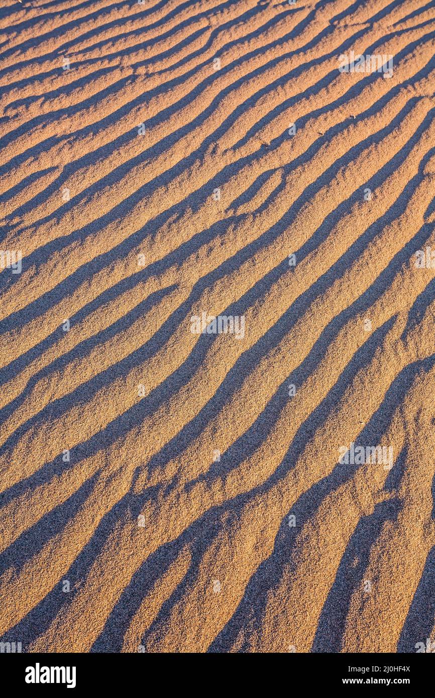 The sand lies in light waves Stock Photo - Alamy