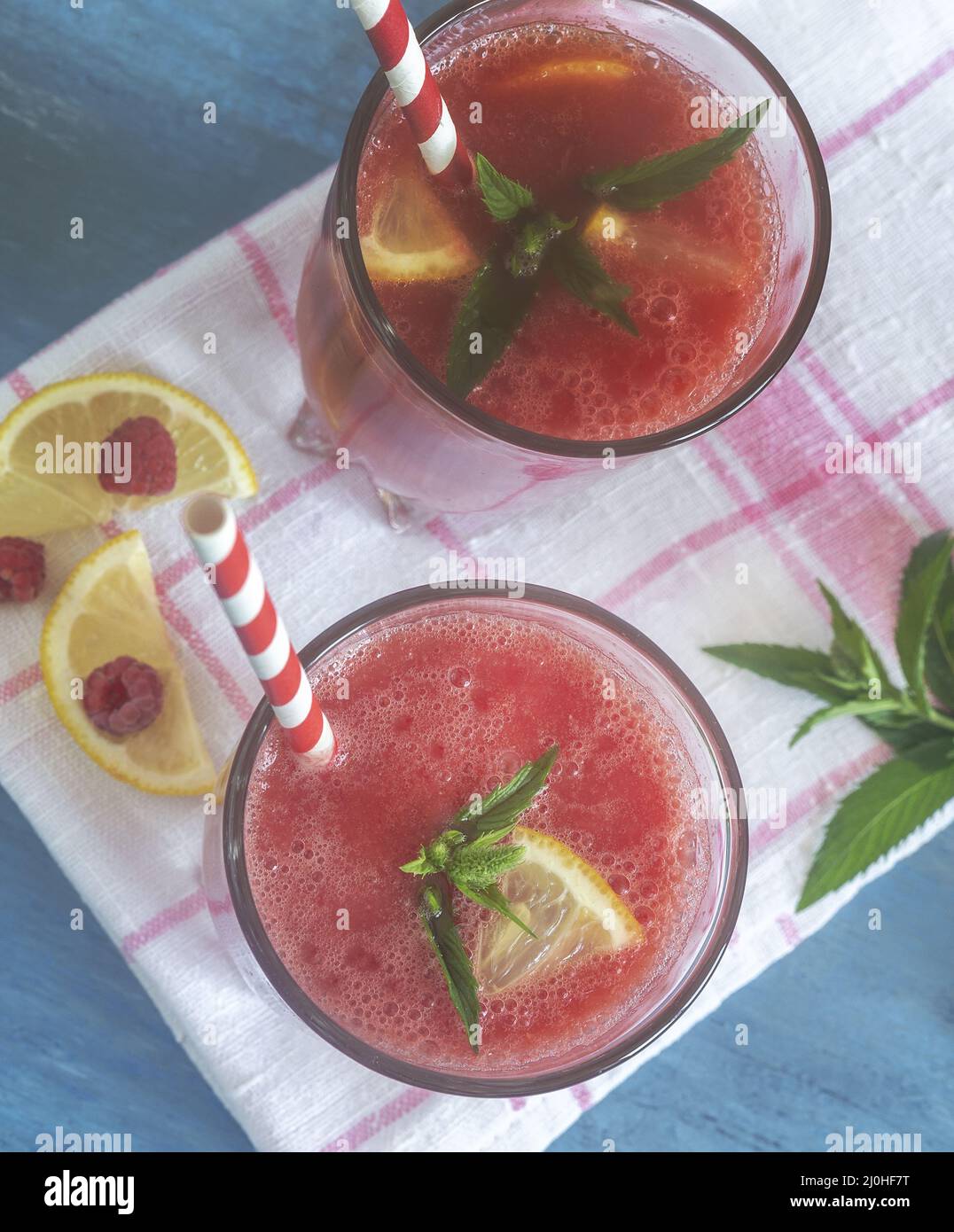 Watermelon juice in a glass with lemon and raspberries Stock Photo - Alamy