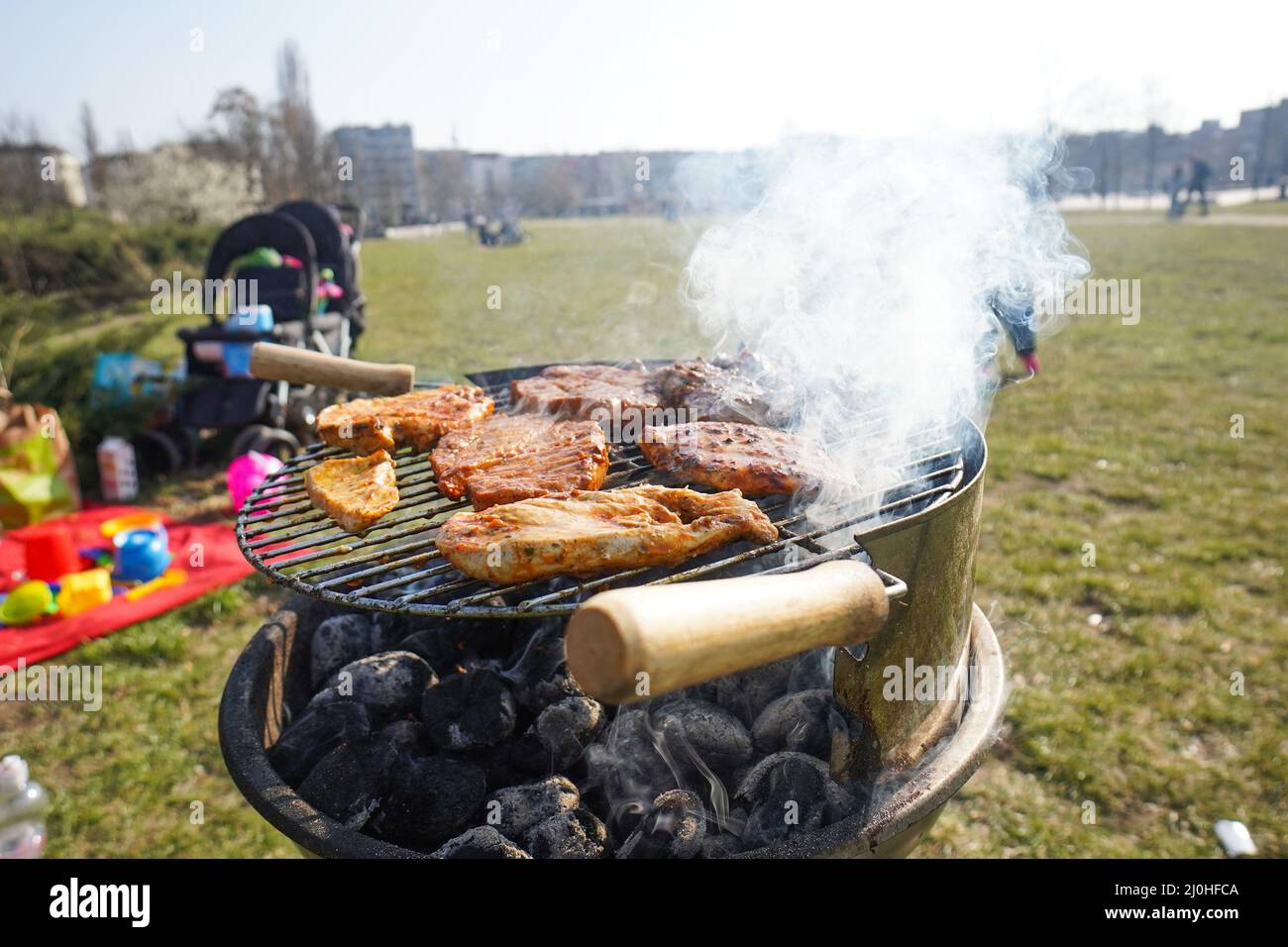 19 March 2022, Berlin: A barbecue will be held in Mauerpark in sunny ...