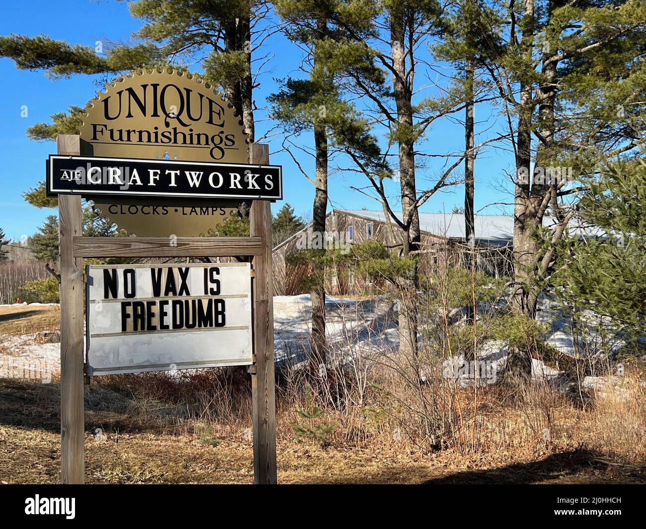 A sign reads No VAX IS FREEDUMB at Ajf Craftworks in Belgrade, Maine on ...