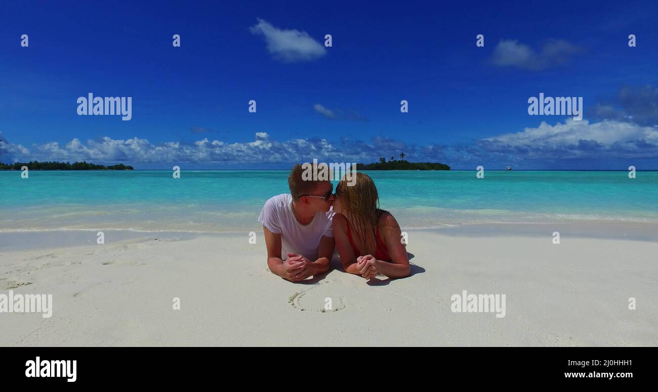 Couple relaxing on the beach in the Maldives Stock Photo - Alamy