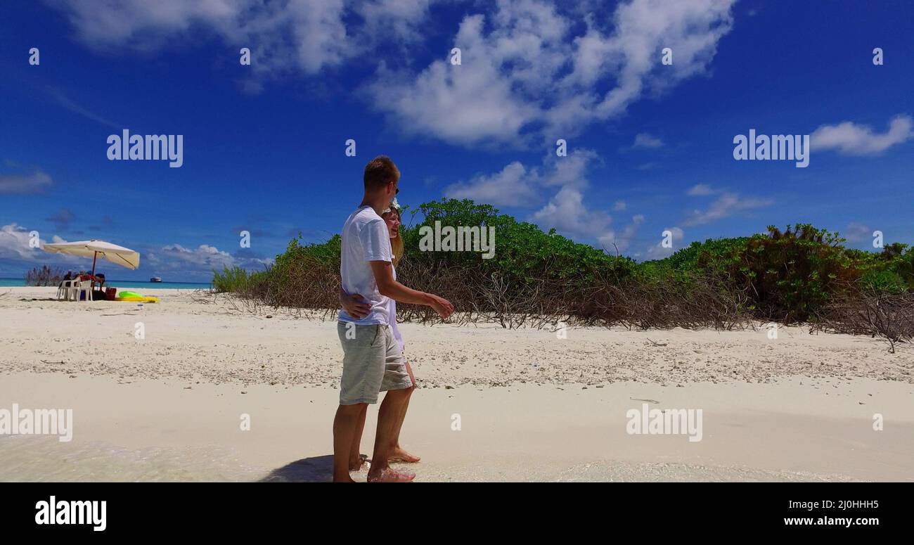 Couple relaxing on the beach in the Maldives Stock Photo - Alamy