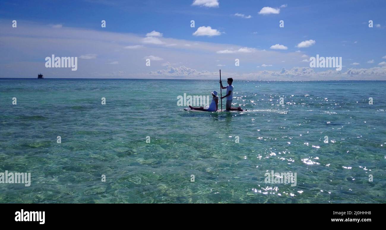Couple relaxing on the beach in the Maldives Stock Photo - Alamy