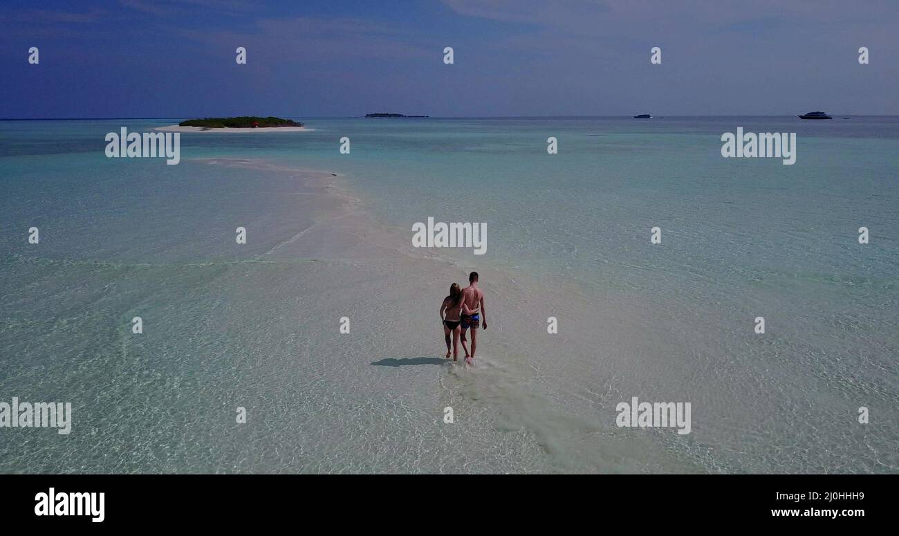 Couple relaxing on the beach in the Maldives Stock Photo - Alamy