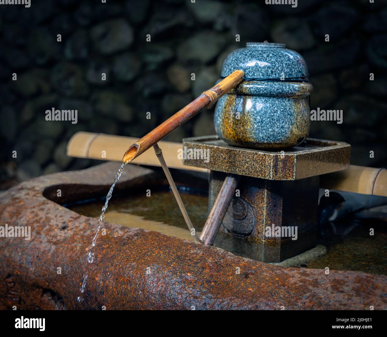 Water flows at a purification area near a shrine in Kyoto, Japan Stock ...