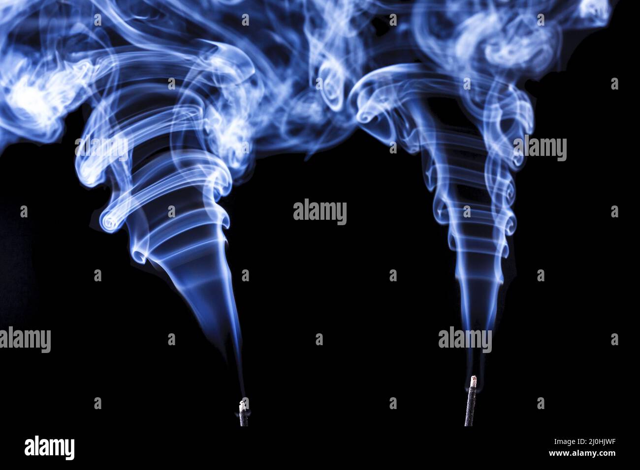 Two plumes in blue incense smoke Stock Photo - Alamy