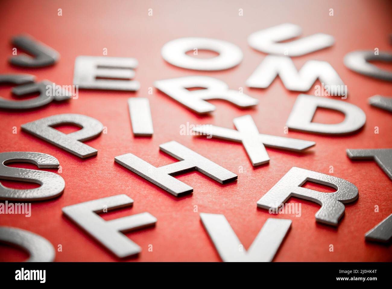 Mixed letters pile close up view photo. Red background Stock Photo - Alamy