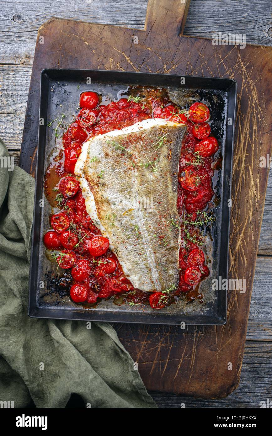 Traditional skinned backed skrei cod fish filet with tomato salsa ragu ...