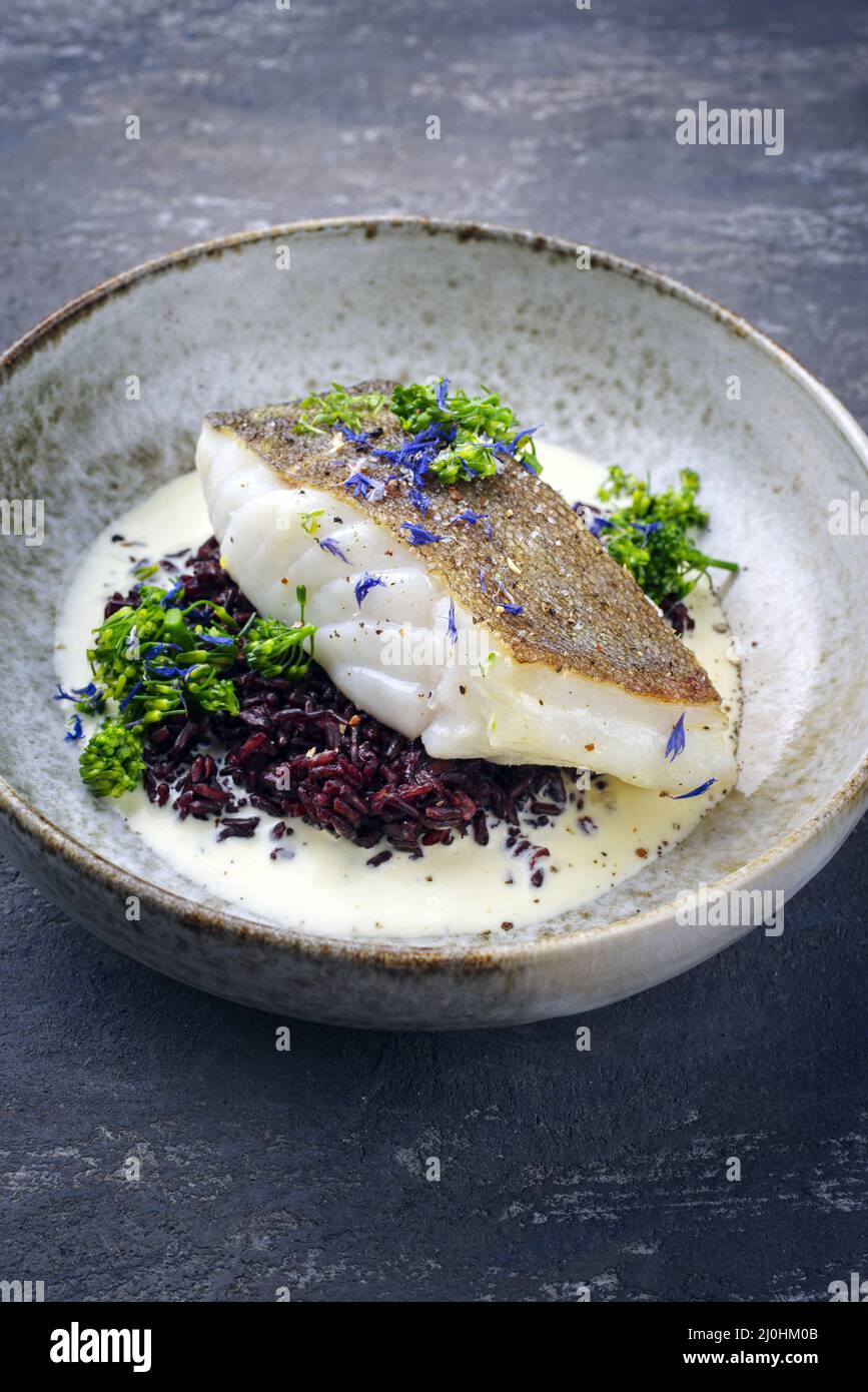 Modern style traditional fried skrei cod fish filet with baby broccoli ...