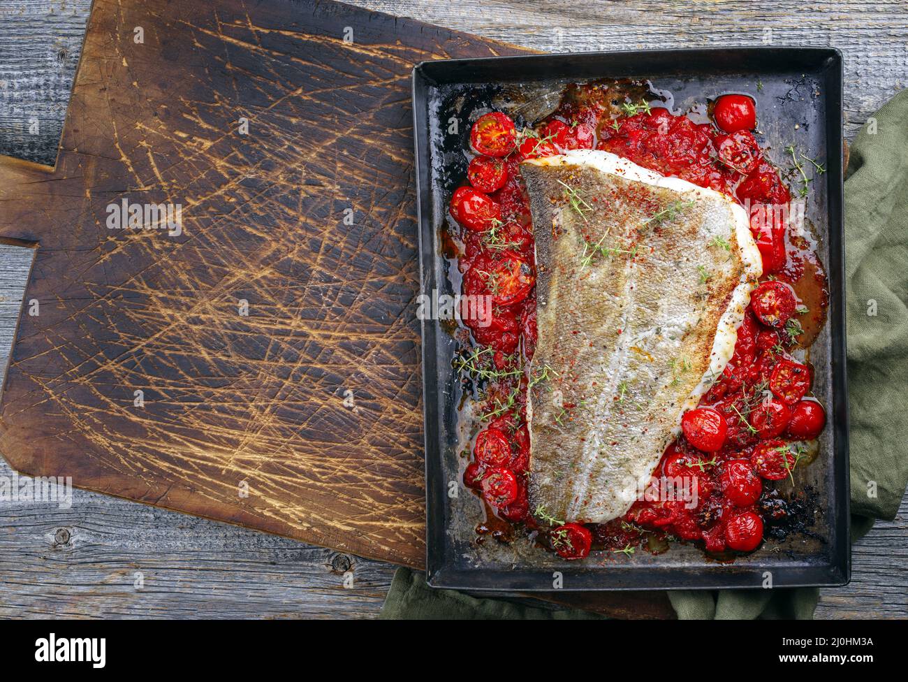 Traditional skinned backed skrei cod fish filet with tomato salsa ragu ...
