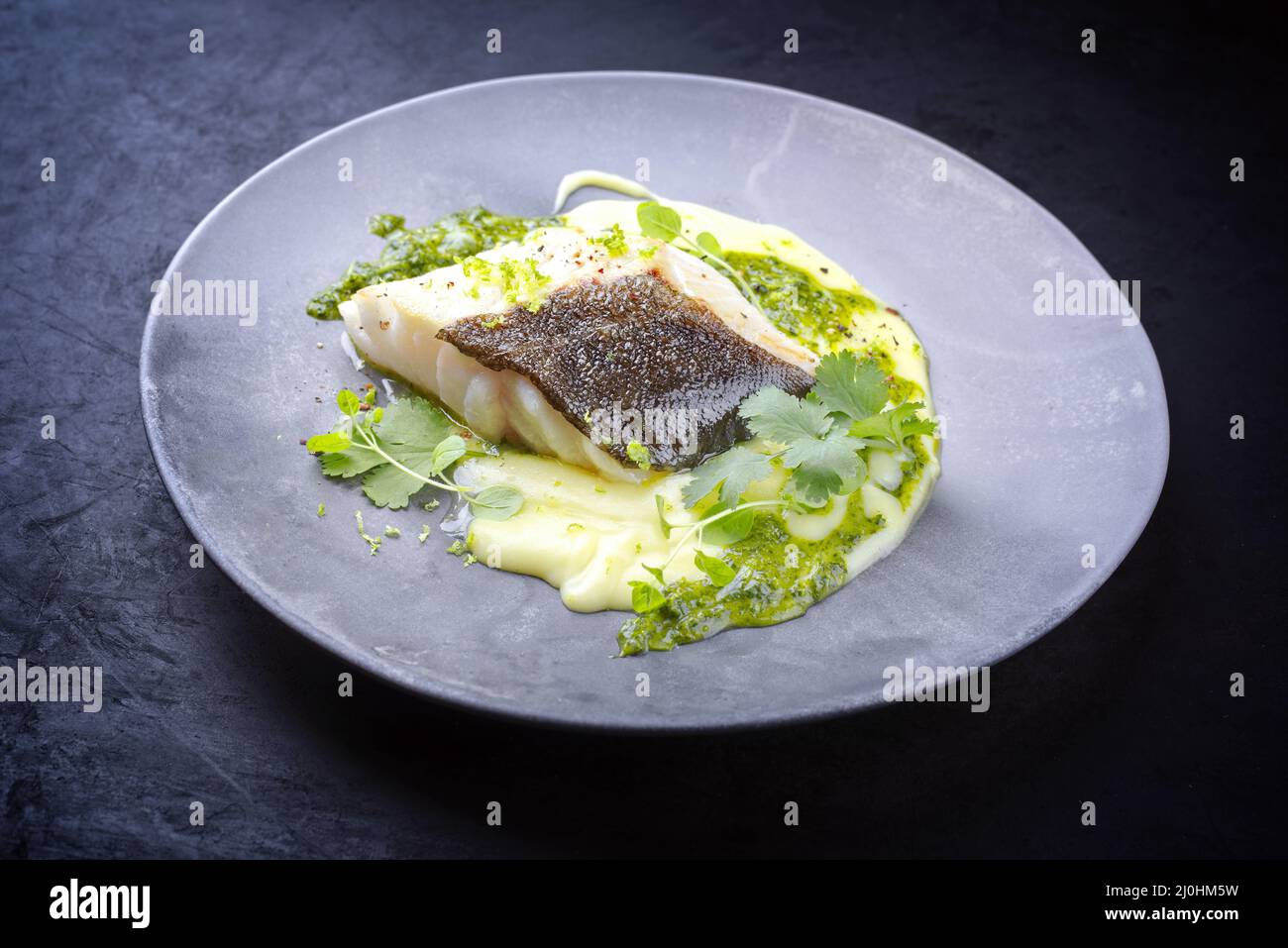 Modern style traditional fried skrei cod fish filet with mashed potato ...