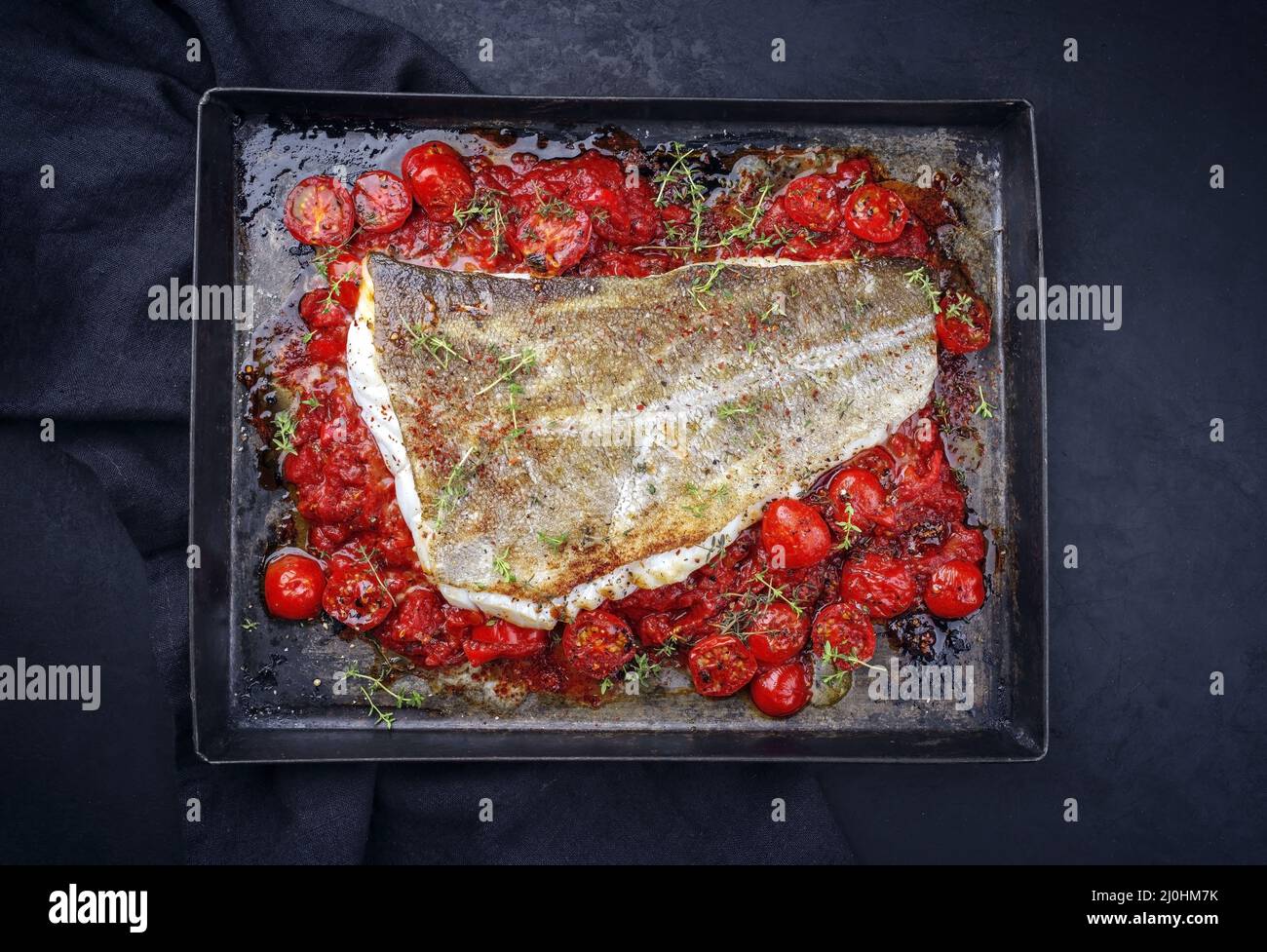 Traditional skinned backed skrei cod fish filet with tomato salsa ragu ...
