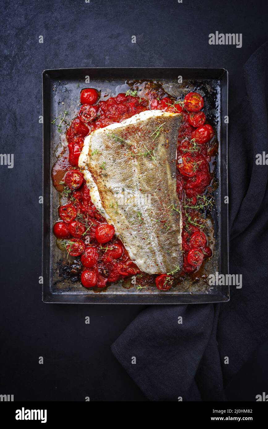 Traditional skinned backed skrei cod fish filet with tomato salsa ragu ...