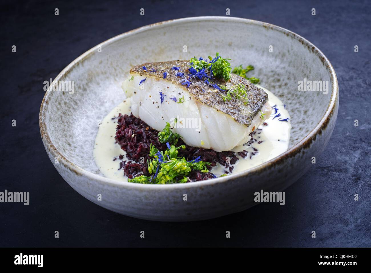 Modern style traditional fried skrei cod fish filet with baby broccoli ...