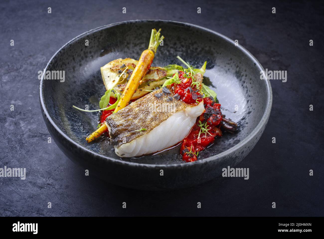Modern style traditional fried skrei cod fish filet with fennel and ...