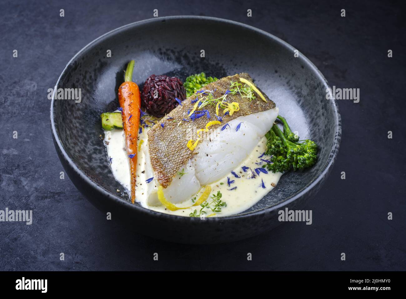 Modern style traditional fried skrei cod fish filet with baby broccoli ...