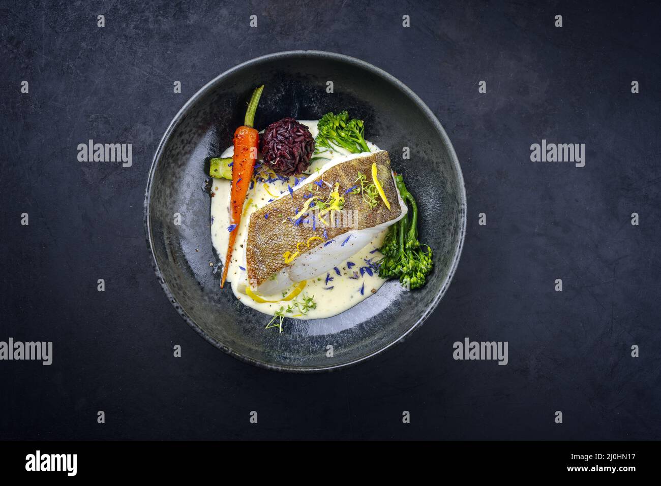 Modern style traditional fried skrei cod fish filet with baby broccoli ...