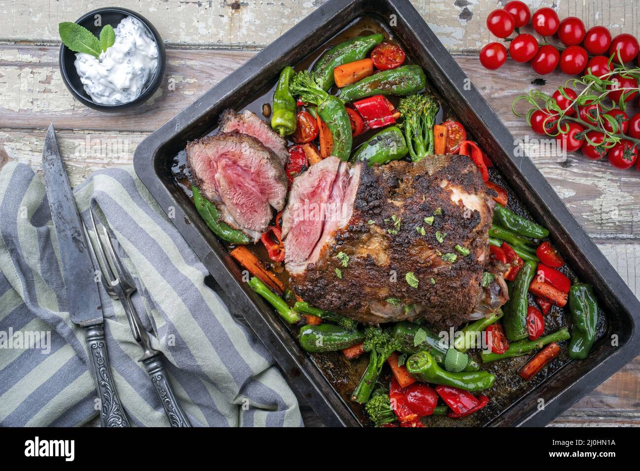 Traditional Greek barbecue lamb roast with vegetable and tzatziki ...