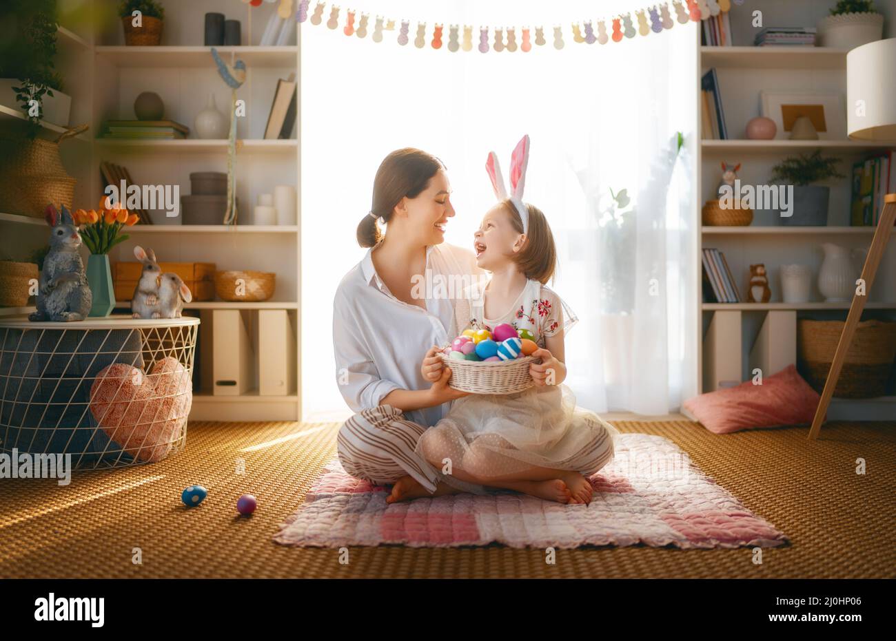 Happy holiday! Mother and her daughter with painting eggs. Family ...