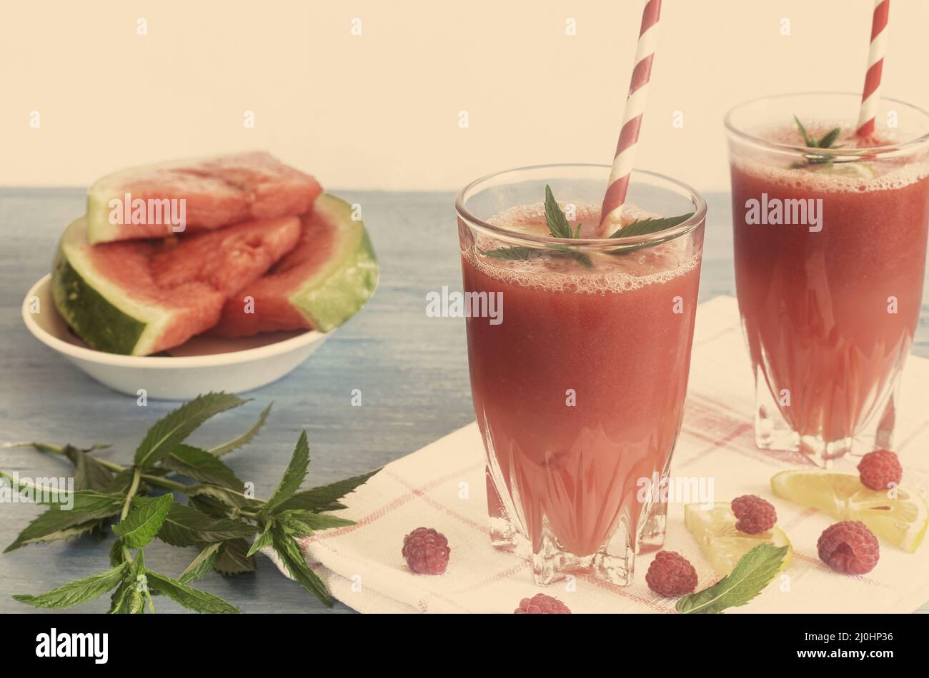 Watermelon juice in a glass with lemon and raspberries Stock Photo - Alamy