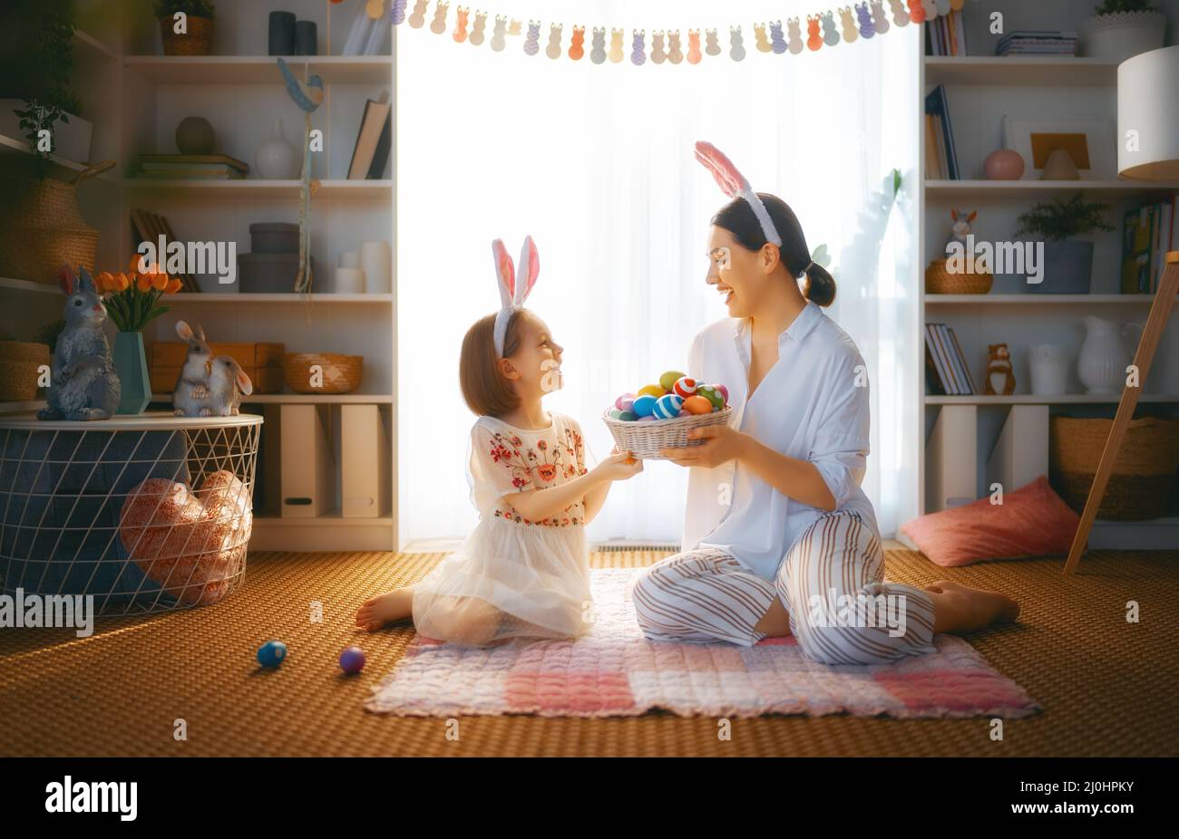 Happy holiday! Mother and her daughter with painting eggs. Family ...