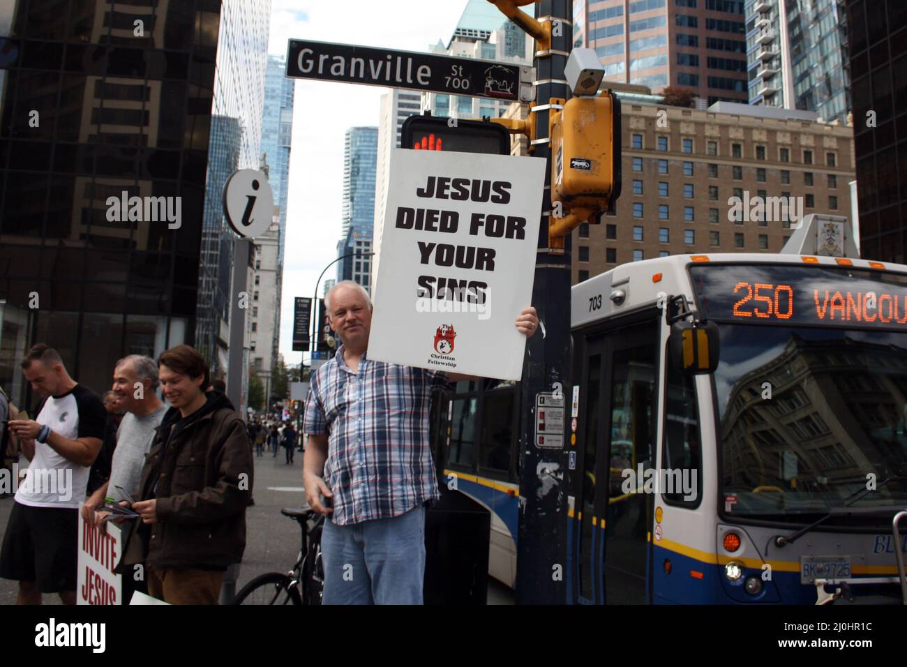 Closeup of a man with a poster saying "Jesus died for you sins Stock ...