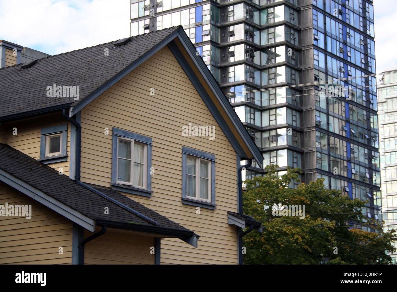 Old wooden house and modern high rise building in downtown Vancouver ...