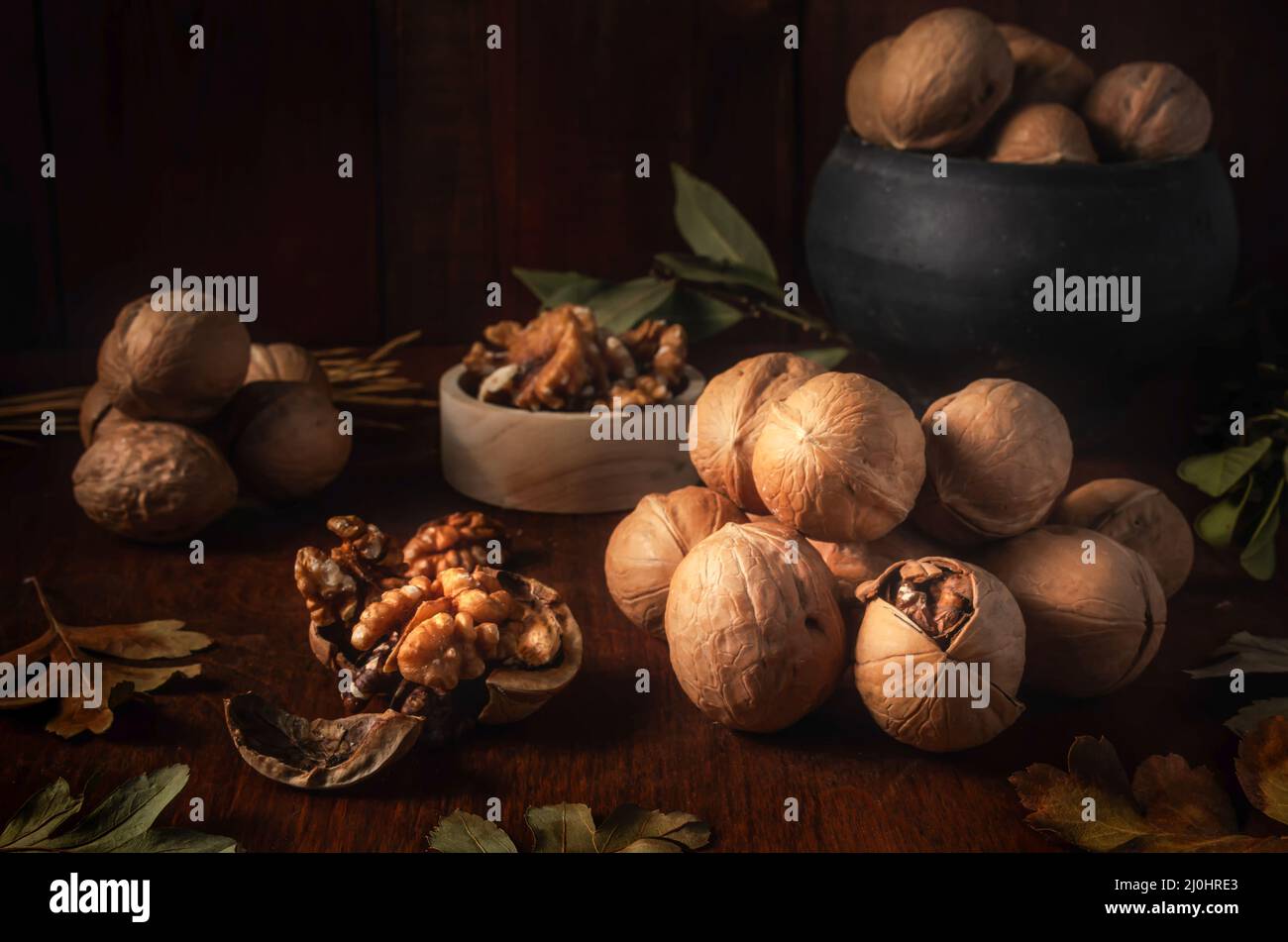 Walnuts on a dark background in a rustic style Stock Photo - Alamy