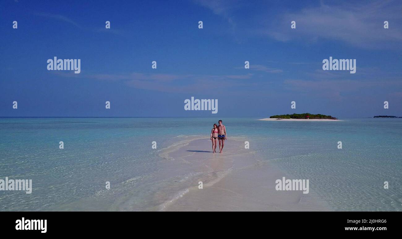 Aerial view of a couple on honeymoon in Rasdhoo Island in the Maldives ...
