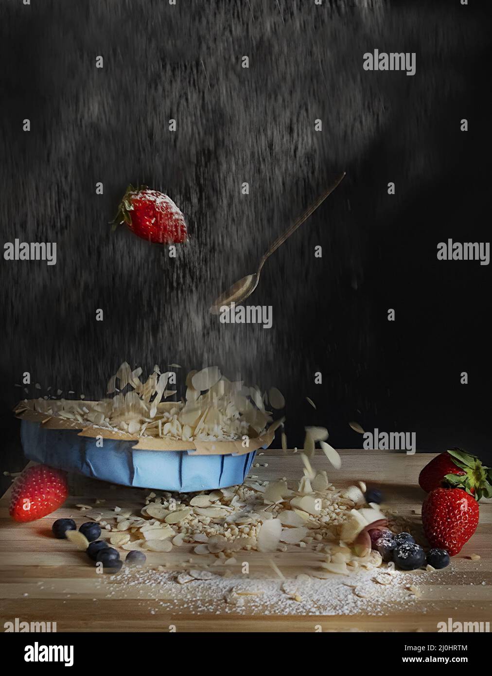 cake falls from above in a cloud of powdered sugar Stock Photo - Alamy