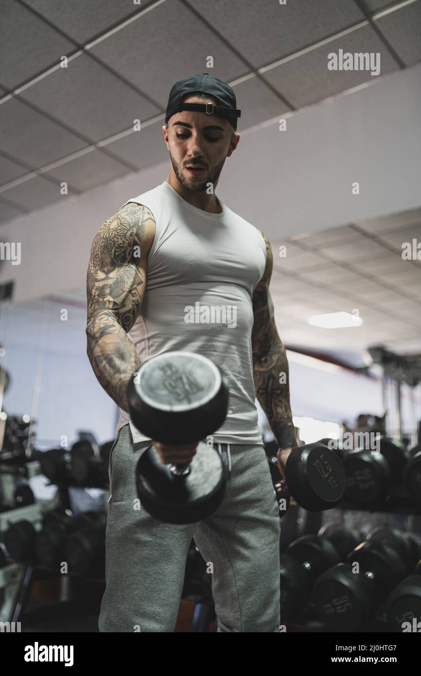 Handsome man doing a workout in the gym Stock Photo - Alamy