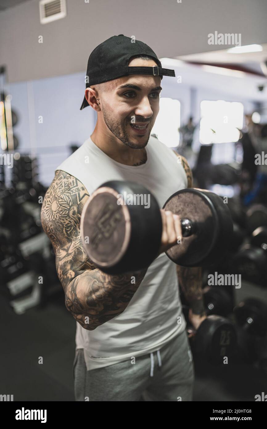 Handsome man doing a workout in the gym Stock Photo - Alamy